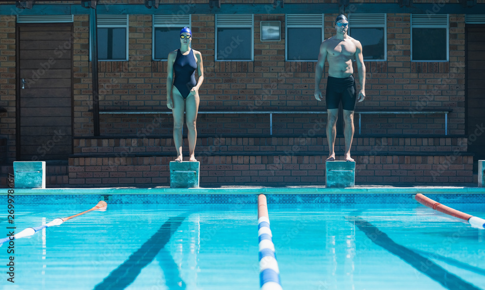 Young swimmers standing on the starting blocks at swimming pool Stock ...