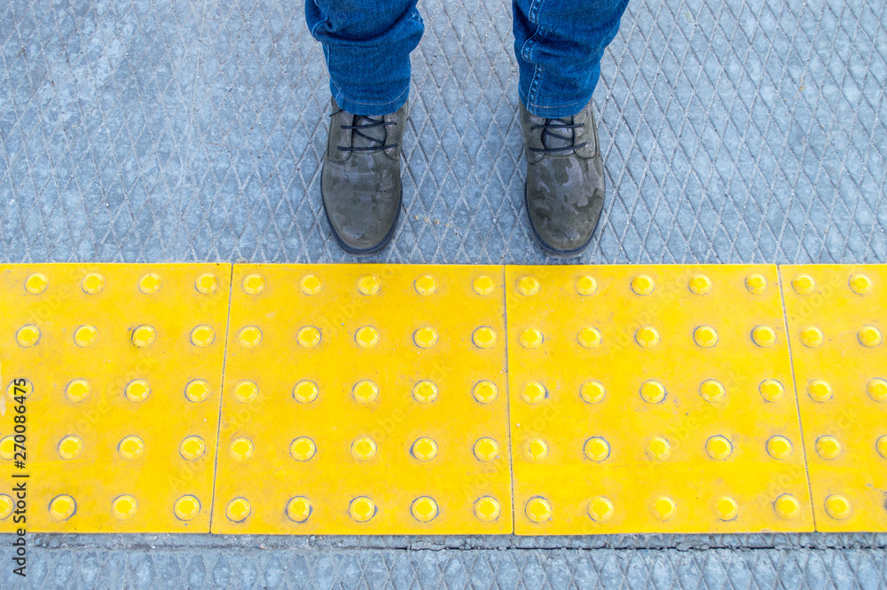 Shoes on block tactile paving for blind handicap. Tactile paving for ...
