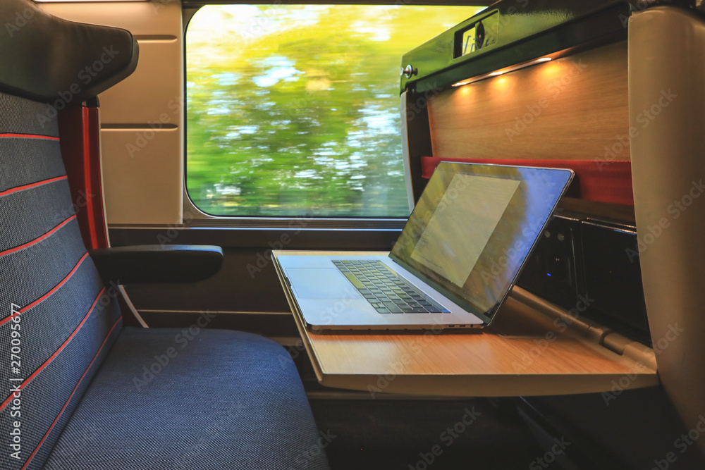 Comfortable seat in first class with laptop on train compartment Stock ...