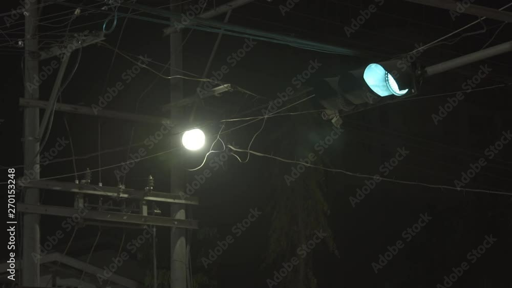 Evening view of traffic light going from red to green on a street in ...