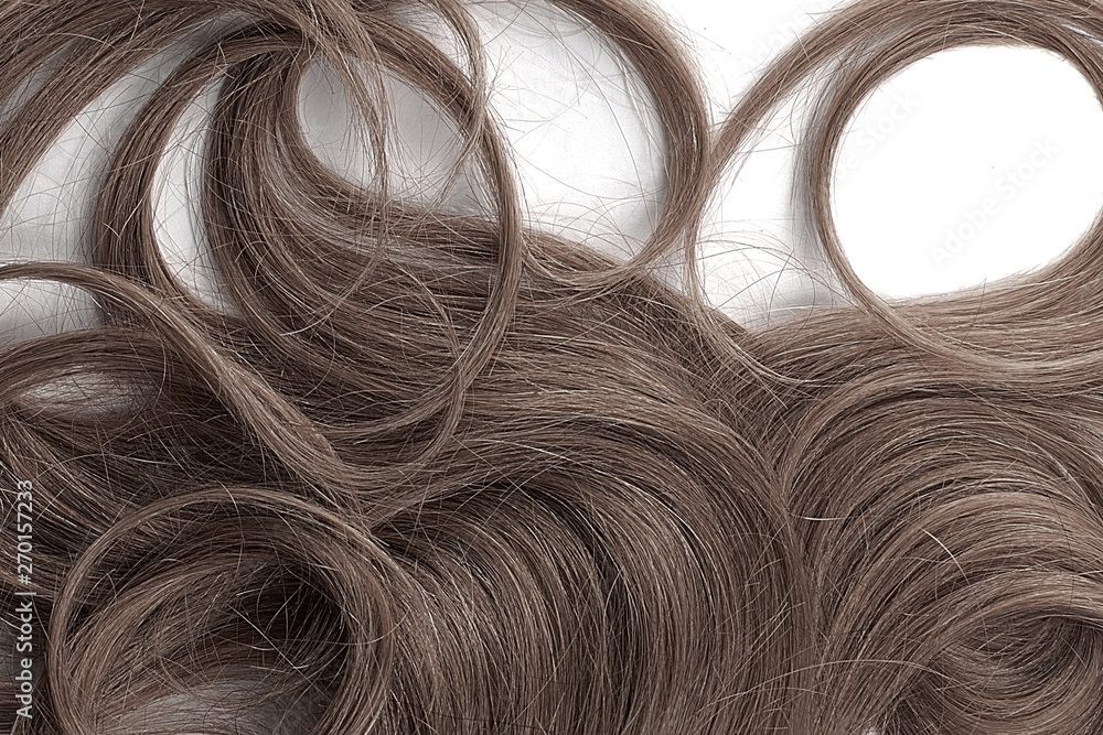 Curly brown hair as background, texture. One of the popular shades of ...