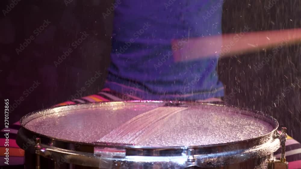 Vidéo Stock Teen boy in blue suit playing drum in rain. child holds ...