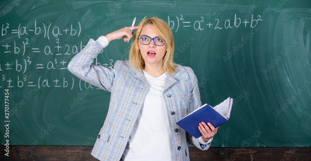 Teacher woman explain near chalkboard. School teacher explain things ...