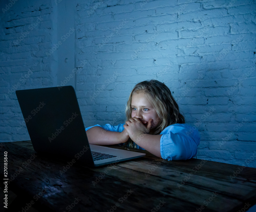Sad young girl with laptop suffering bullying and harassment online ...