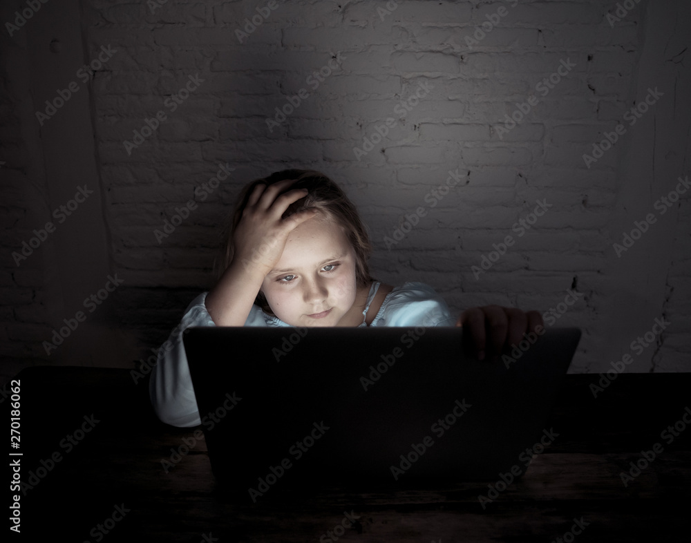 Sad young girl with laptop suffering bullying and harassment online ...