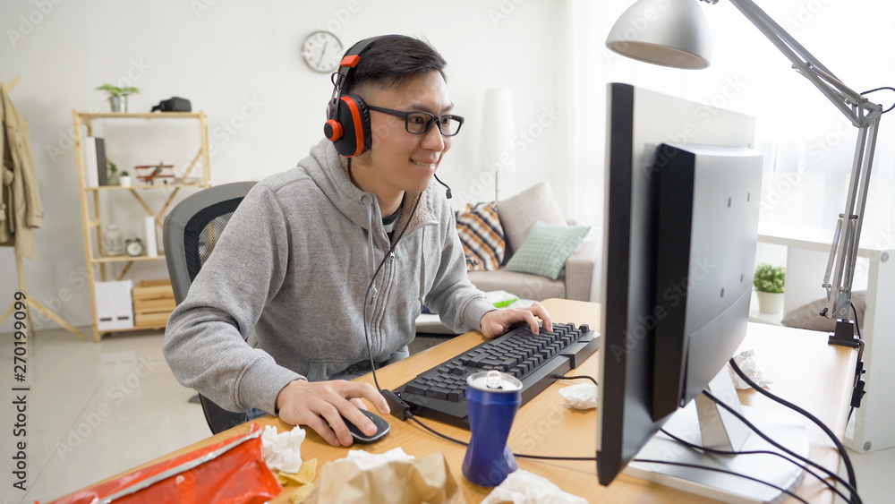 portrait of nervous gamer guy playing video games on computer wearing ...