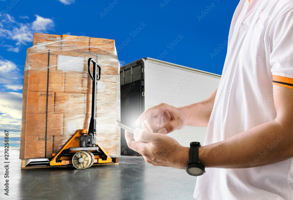 warehouse and transportation. shipper man hand holding smartphone his ...