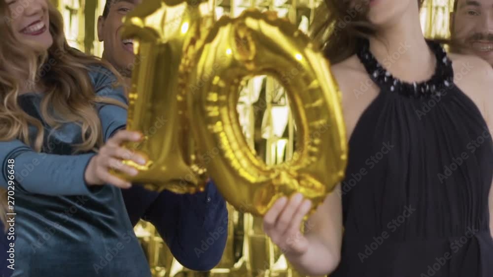 The number 10 of foil. 4 happy cheerful people at a party with balloons ...