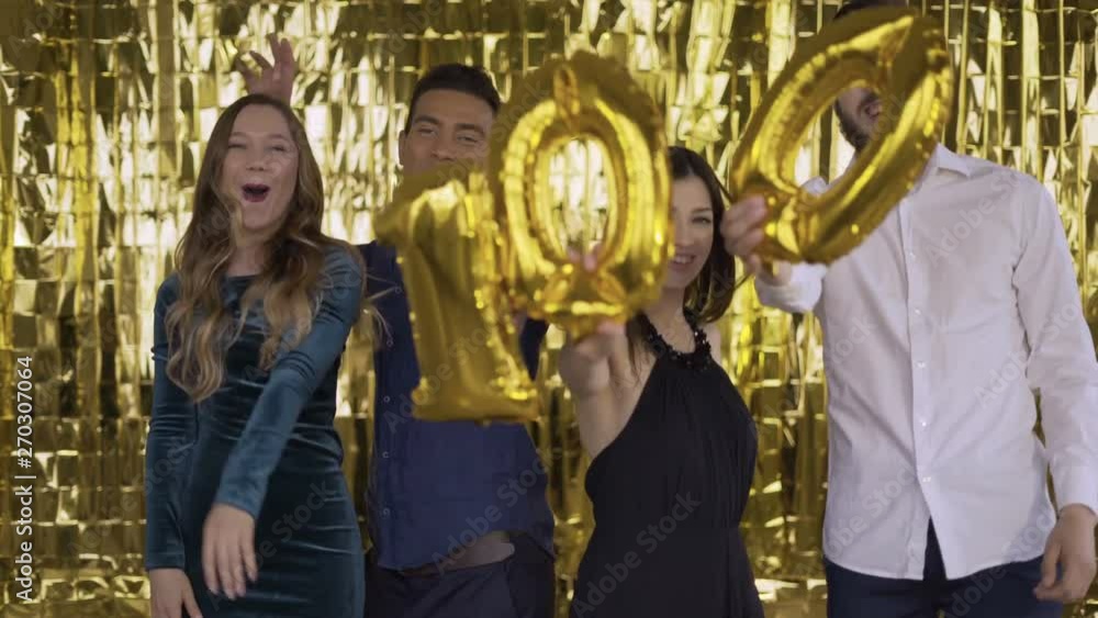 The number 100 of foil. 4 happy cheerful people at a party with ...
