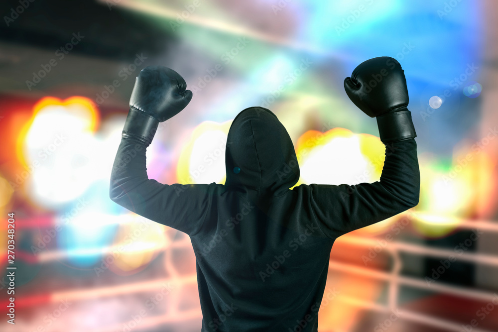 boxer without a name closed by a black overalls raised his hands up in ...