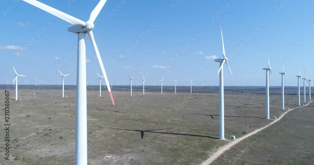 4K aerial wiev of windmills farm. Modern wind turbines. Wind is ...