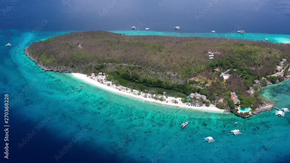 Aerial view of the Sumilon island, sandy beach with tourists swimming ...