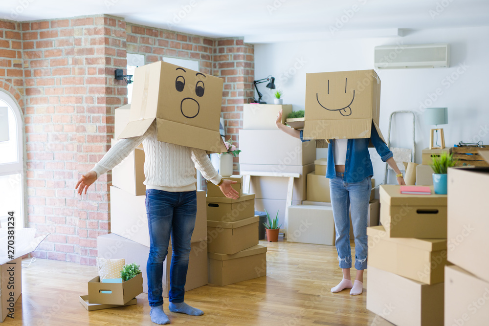 Funny couple wearing cardboard boxes with fun crazy emoji faces over ...