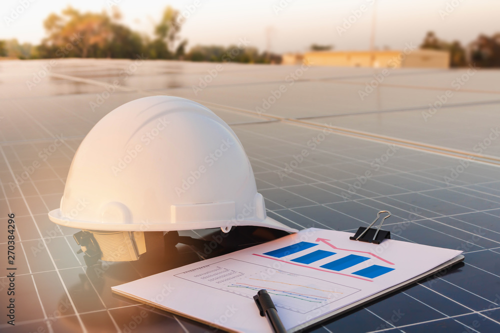 Engineers are examining the performance graph of energy production from ...