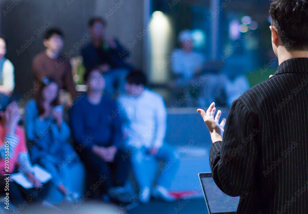 Seminar presenter at corporate conference giving speech. Speaker giving ...