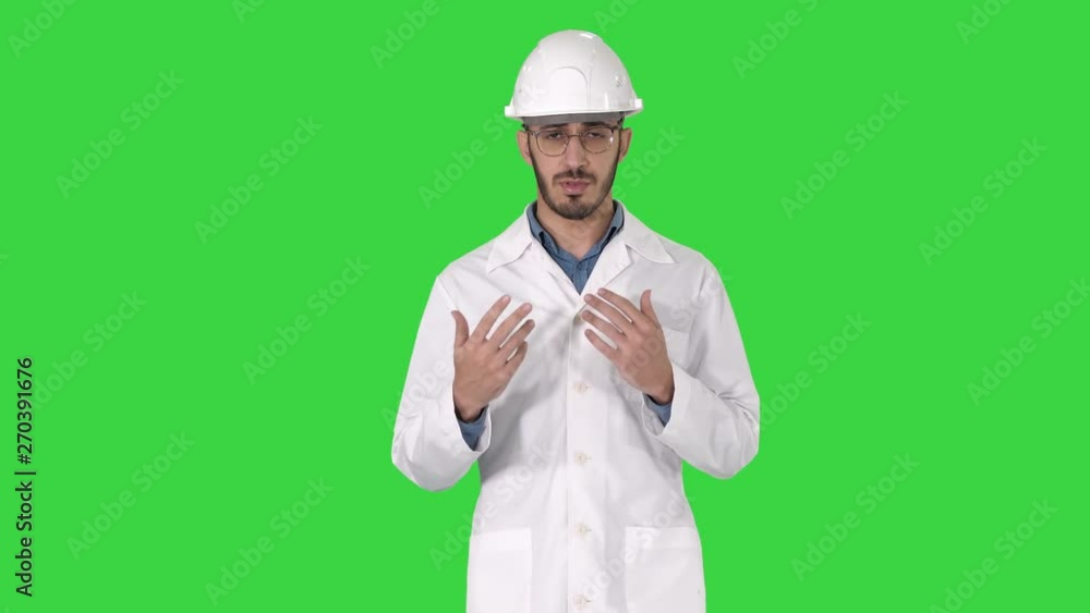 Scientist in white robe and helmet presenting pointing to side with ...