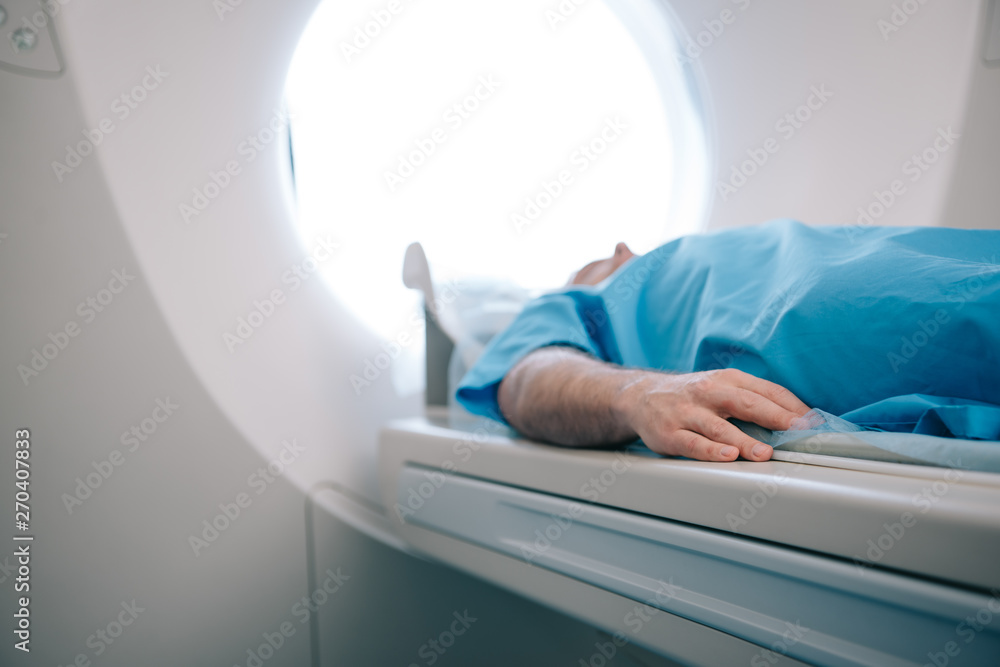 selective focus of patient lying on ct scanner bed during tomography ...