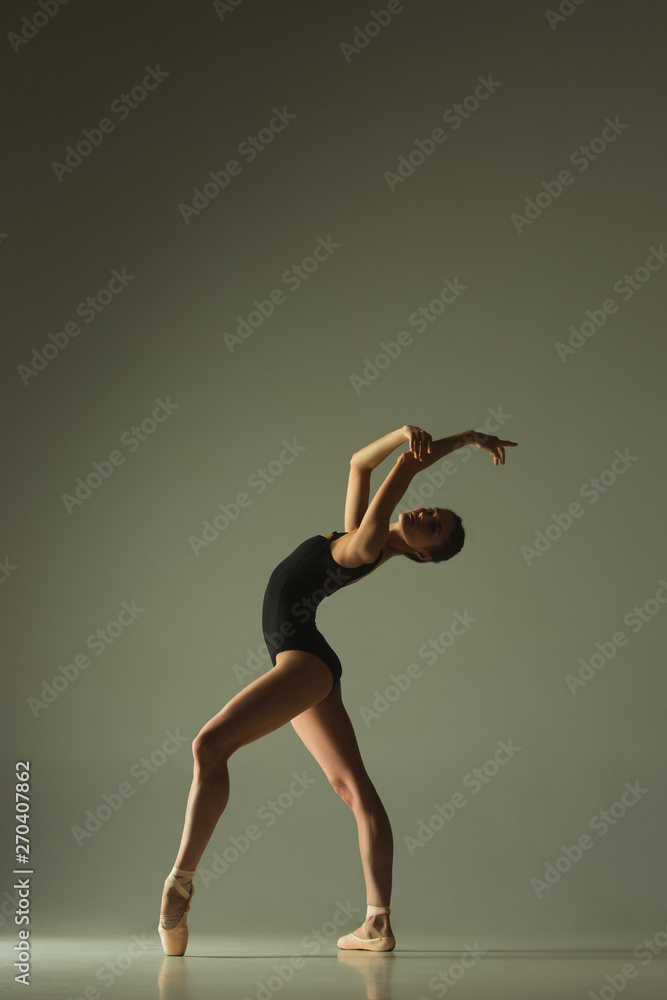 Graceful ballet dancer or classic ballerina dancing isolated on grey ...