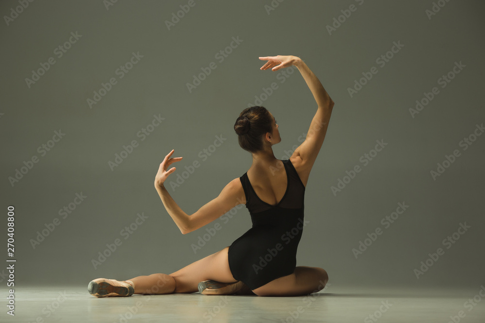 Graceful ballet dancer or classic ballerina dancing isolated on grey ...