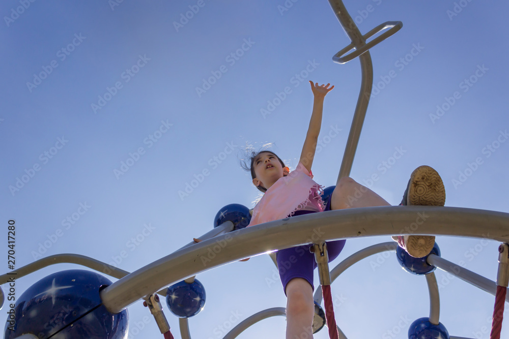 teenage girl playing with motor activity developer toys like rope wall ...