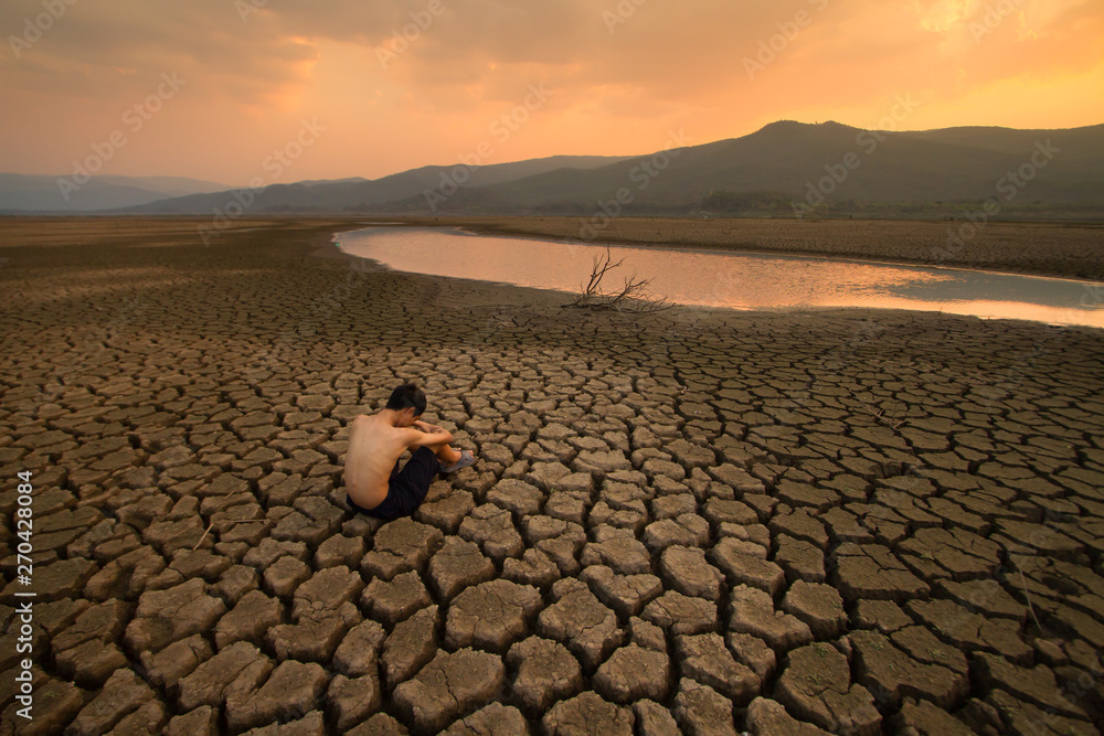 Poster Water crisis, Sad Children sitting on cracked earth near drying ...