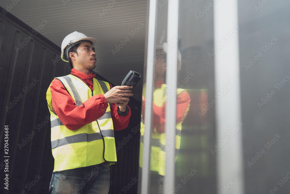 Asian man reefer technician is seriously working and monitoring reefer ...