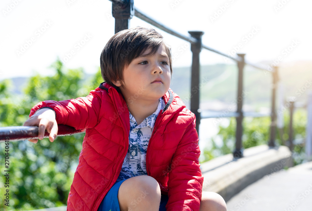 Outdoor portrait of Sad Kid sitting alone next to the fence, Emotional ...