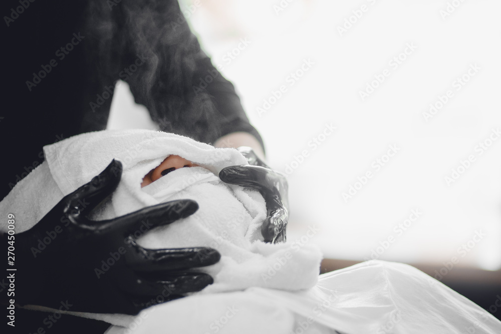 Barber steam face skin of man with hot towel before royal shave in ...