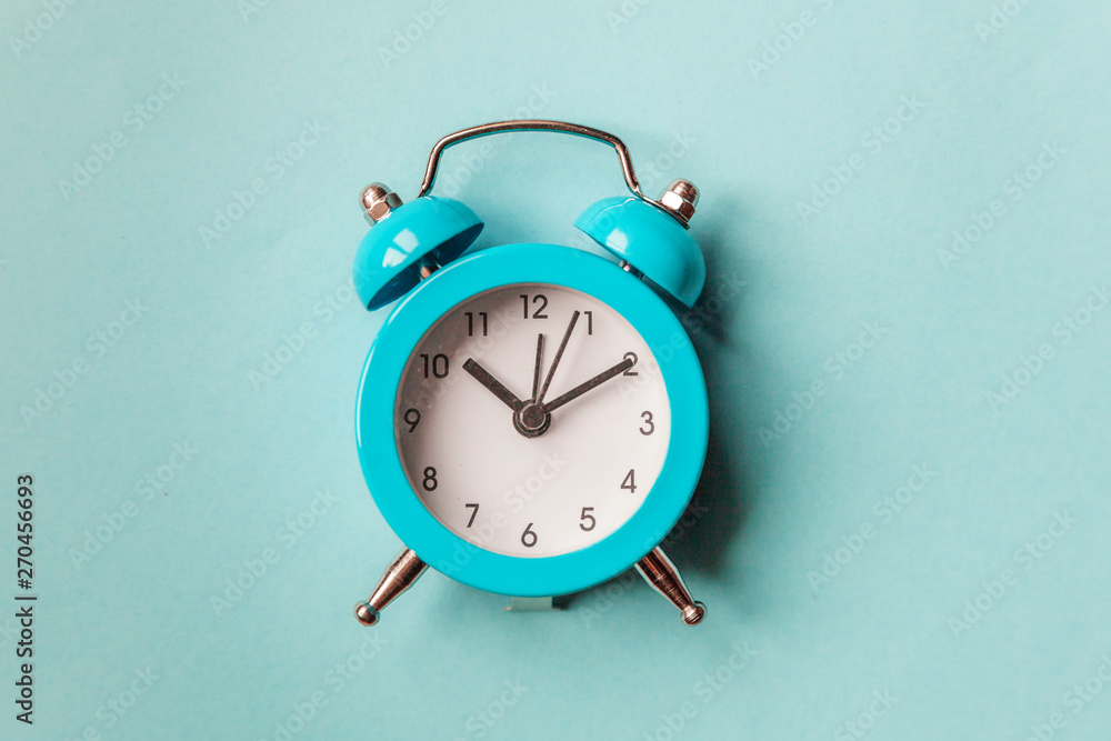 Ringing twin bell vintage classic alarm clock Isolated on blue pastel ...