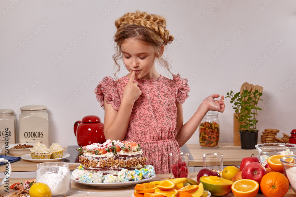 Little girl is making a homemade cake with an easy recipe at kitchen ...