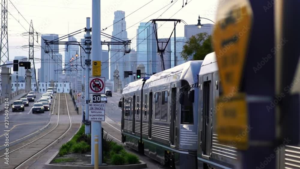 Slow motion of metro train tram driving to downtown cityscape skyline ...