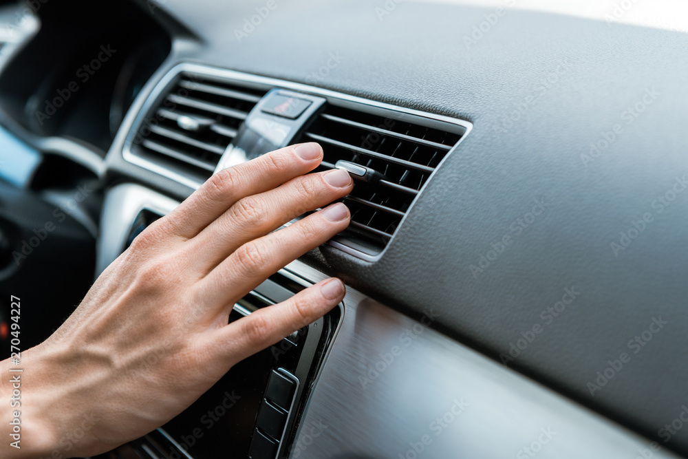 cropped view of man touching air conditioner switch in car Stock Photo ...