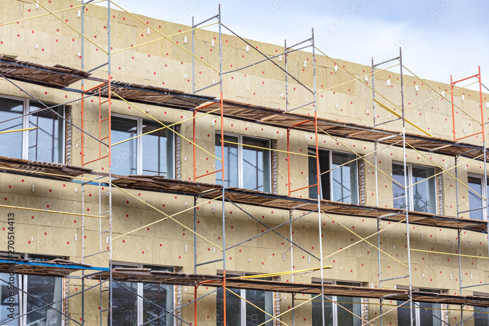 exterior wall thermal protection. building facade under renovation with ...