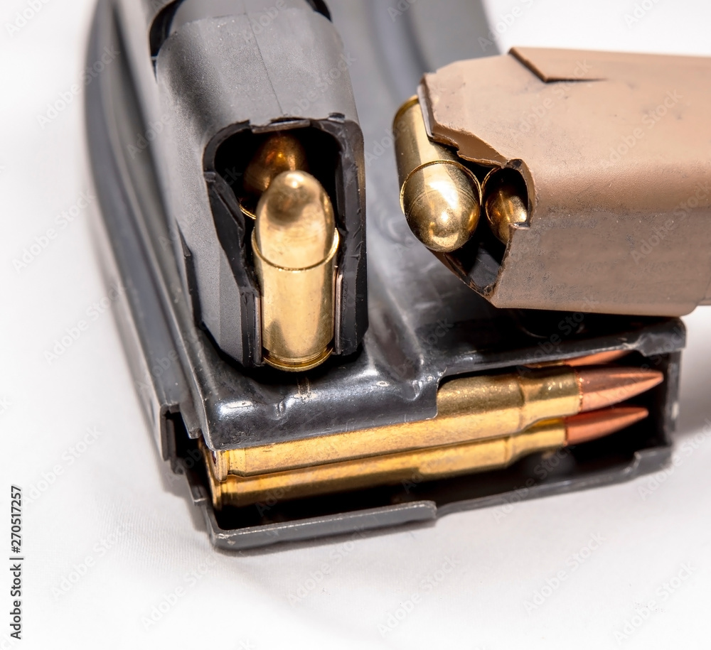 Two loaded 9mm pistol magazines with a loaded 223 caliber magazine on a ...
