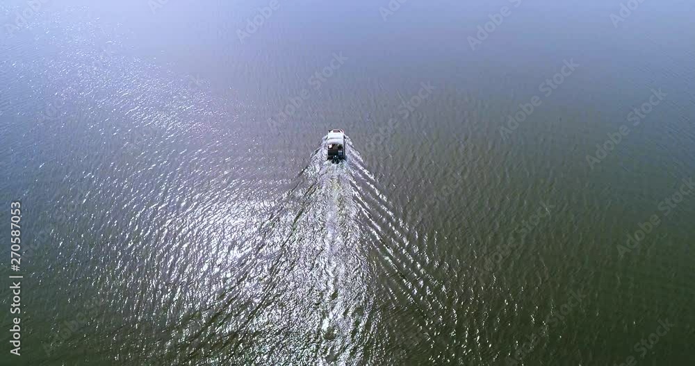 View from above of little ship following the river. Drone footage ...