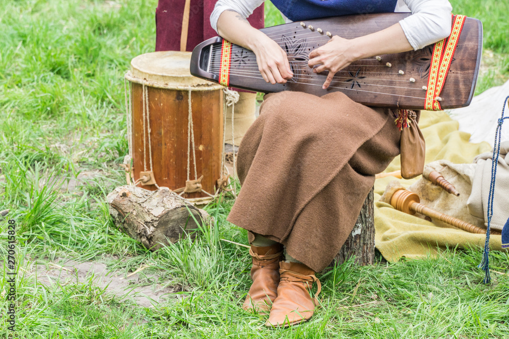 Restoration of old Viking traditions. Playing on an old stringed ...