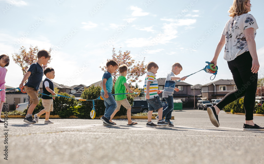 Students and teacher walking outside Stock Photo | Adobe Stock