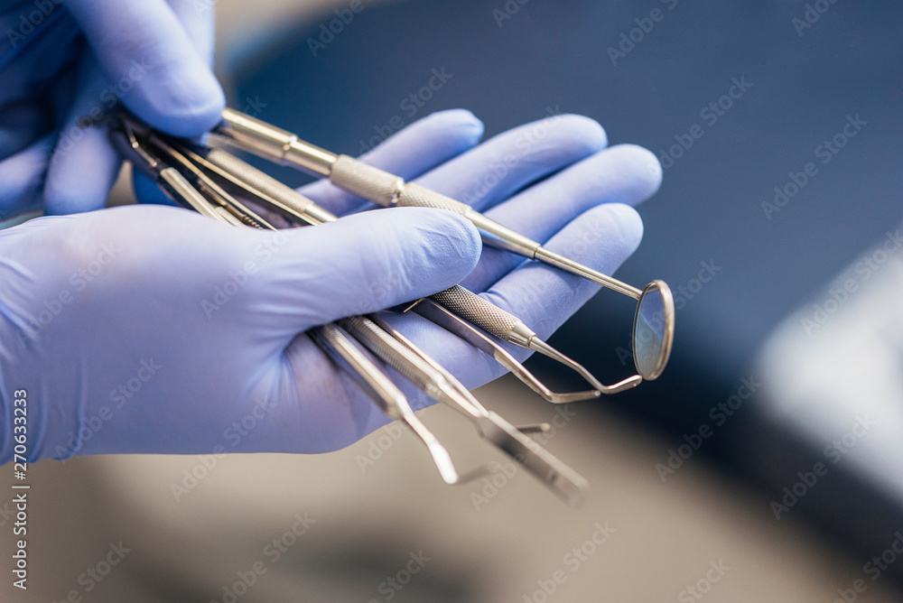 Detail of hand holding dental tools in dental clinic. Stock Photo ...