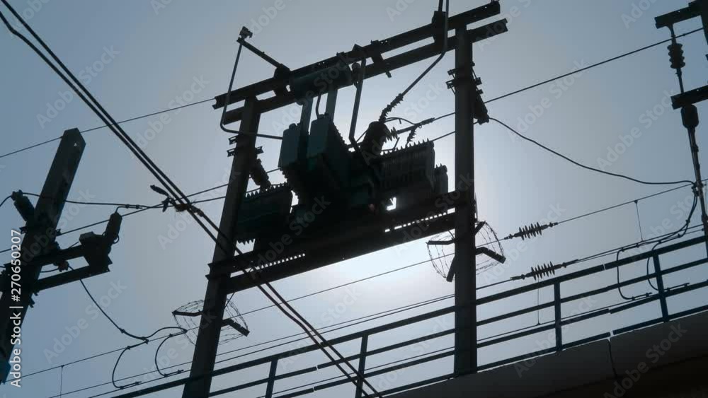 City electric transformer above the ground on two pillars against a ...