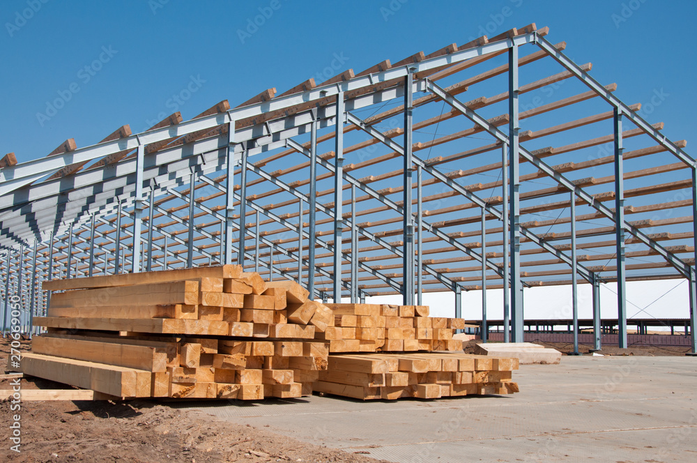 Wooden beams for steel structure for further construction. Metal frame ...
