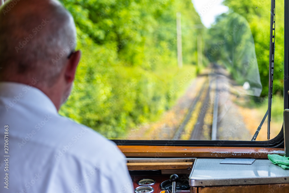 A view from the window of a traveling railroad train, a visible engine ...