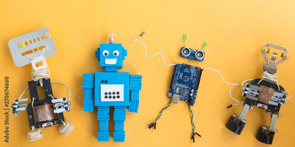 Back to school concept. A metal robot and an electronic board that can ...