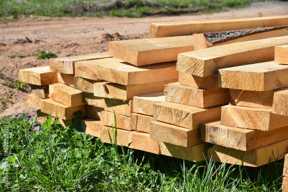 Stacked lumber. Folded wood.Closeup wooden boards.The surface of the ...