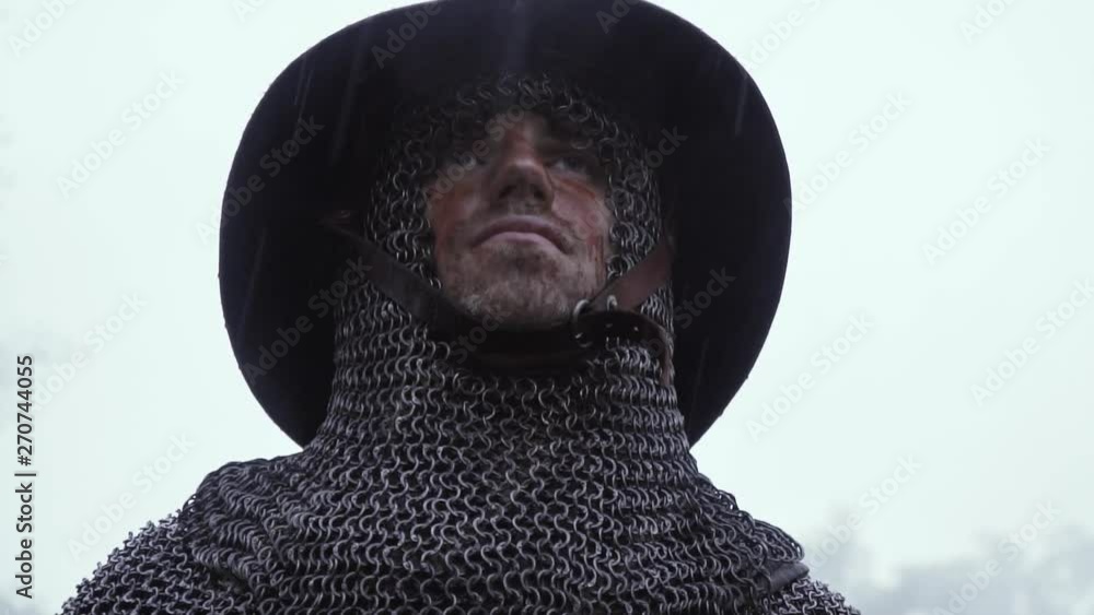 Close up of a medieval soldier in chainmail armor with a sword in the ...