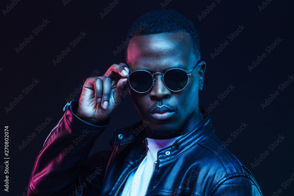 African male model portrait with serious face, wearing trendy ...