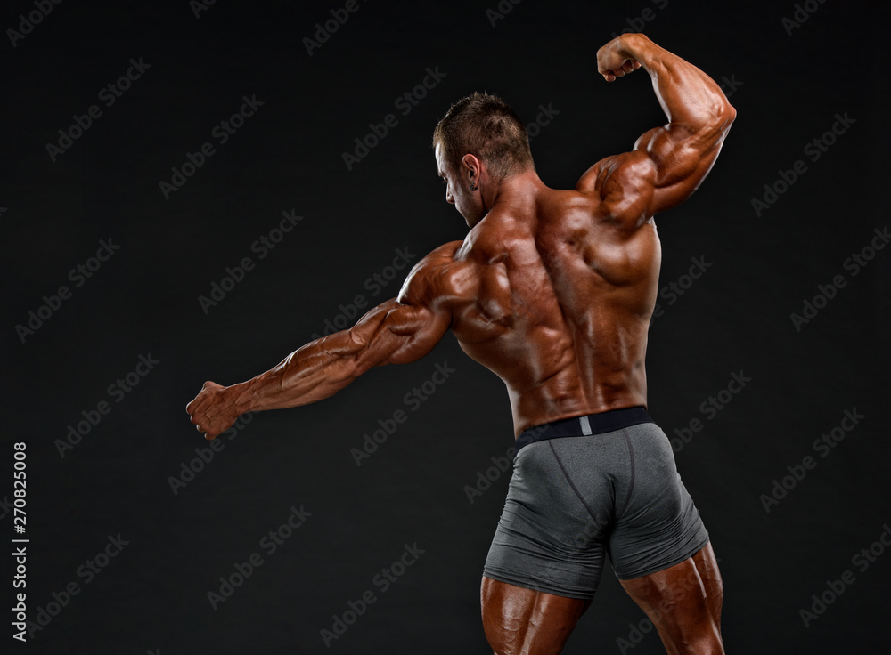 Strong Muscular Men Flexing Muscles from the Back. He is showing back ...