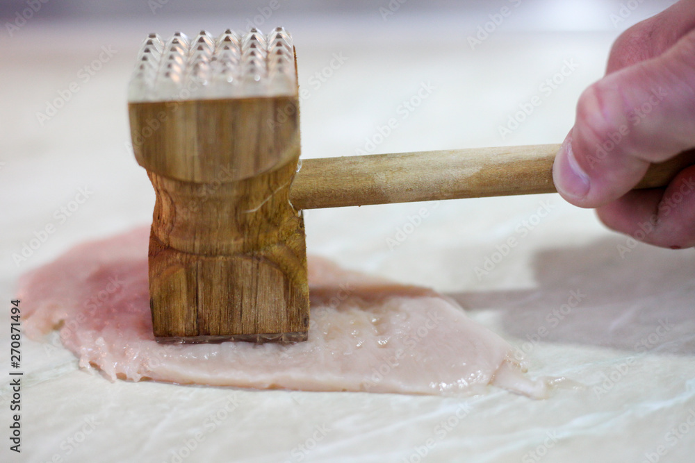 The chef in the kitchen prepares meat for a delicious meal.Koncept ...