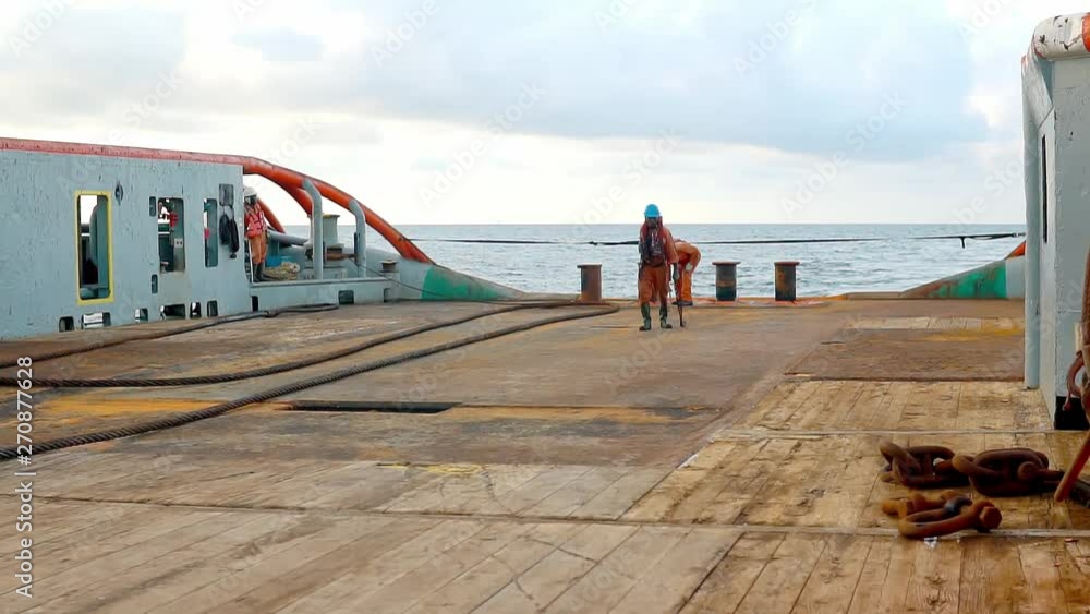 Anchor-handling Tug Supply AHTS vessel crew preparing vessel for static ...