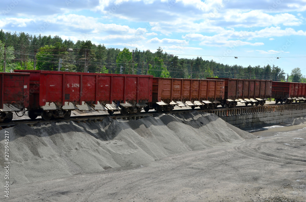 Unloading of crushed stone from railway car. Unloading bulk cargo from ...