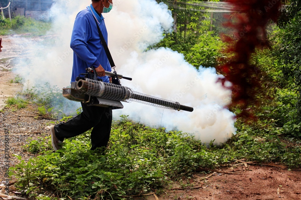 Employees use fogging machines to get rid of mosquitoes to prevent ...